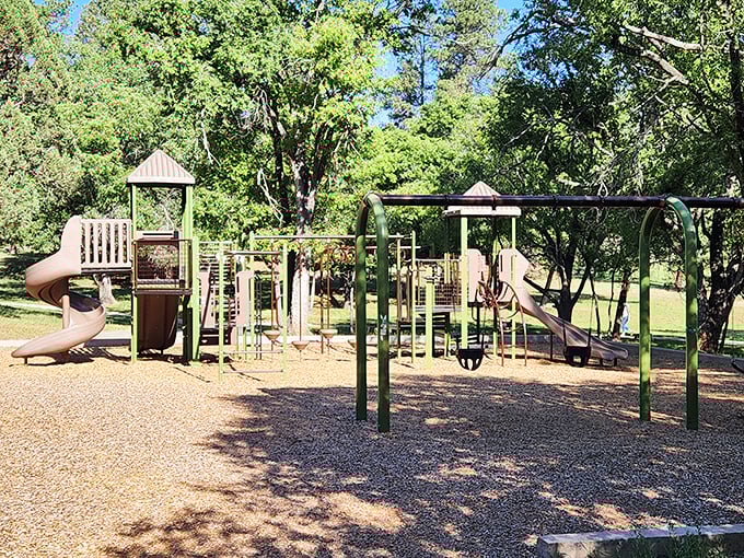 This playground nestled among the pines is where kids burn energy while parents contemplate their next meal choice.