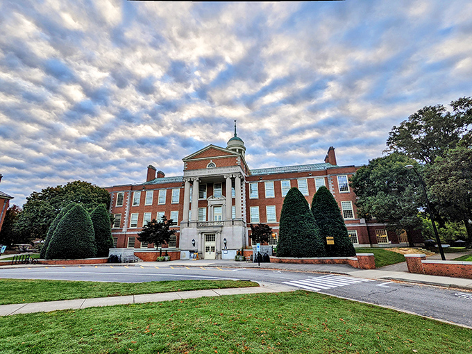 Stately brick and dramatic clouds frame this historic building, where generations of Winston-Salem residents have gathered, learned, and built community connections.