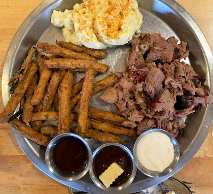 These aren't your average fries. Crispy zucchini sticks, potato salad, and pulled pork create a trifecta of textures that dance across your palate.