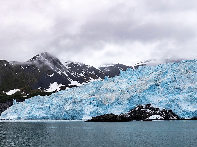 Aialik Glacier's blue ice face towers 400 feet above the water, nature's most impressive demolition show waiting to happen.