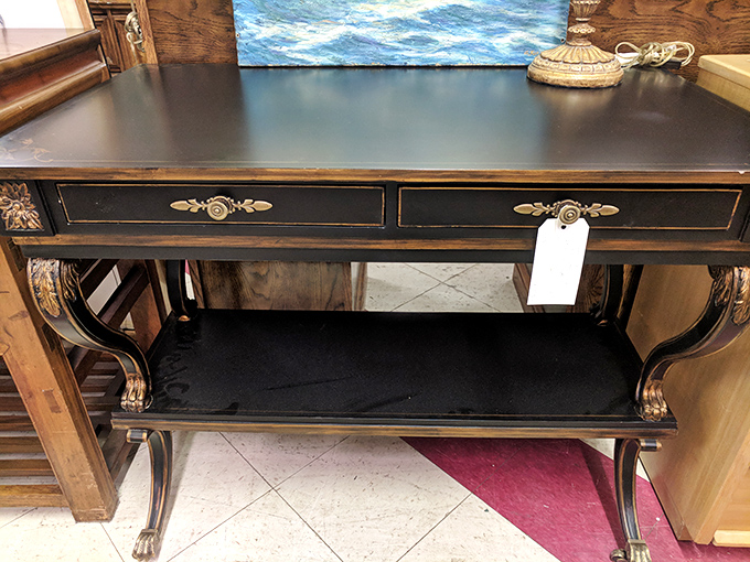 Elegant curves and ornate details make this black console table a standout piece. It's practically begging to display your collection of whatever you collect.