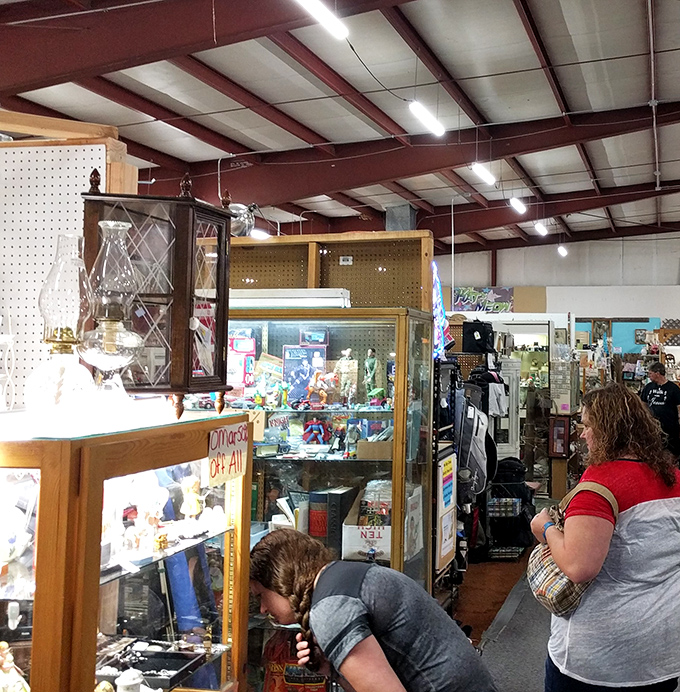 Shoppers examining display cases with the focus of archaeologists on a dig. The thrill of discovery is written all over their faces.