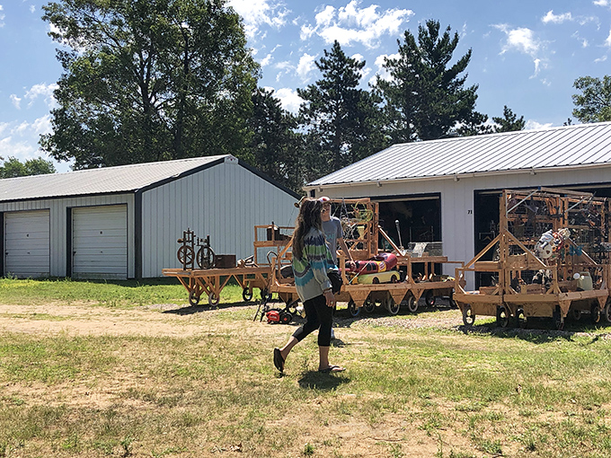 Rustic market buildings under summer skies, with wooden display carts showcasing treasures for eager shoppers.