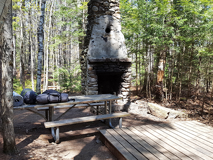The stone fireplace that's witnessed countless s'mores ceremonies. Silent sentinel of campfire stories and the occasional burnt marshmallow.