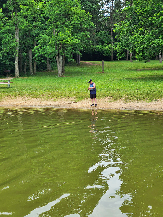 The patient fisherman and his reflection create perfect symmetry on Hargus Lake's surface. Fish stories optional, tranquility guaranteed.