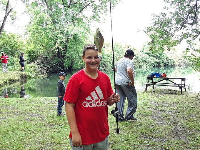 Nothing says "authentic Ohio experience" quite like a proud young angler showing off the day's catch along the peaceful riverbank.