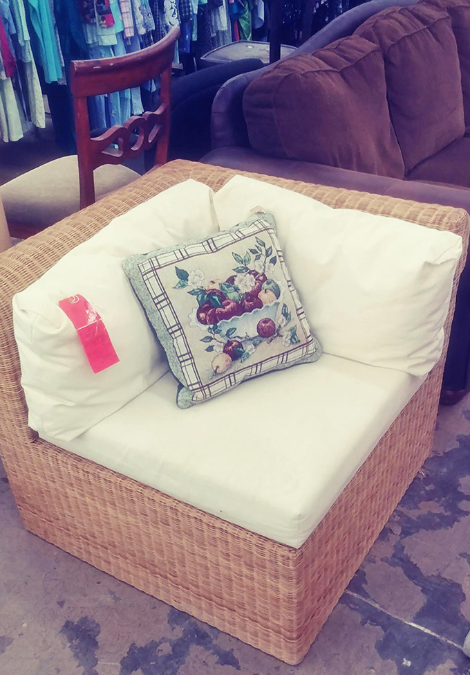 That wicker chair isn't just furniture—it's someone's future reading nook waiting to happen. Complete with fruit-themed pillow for extra charm.