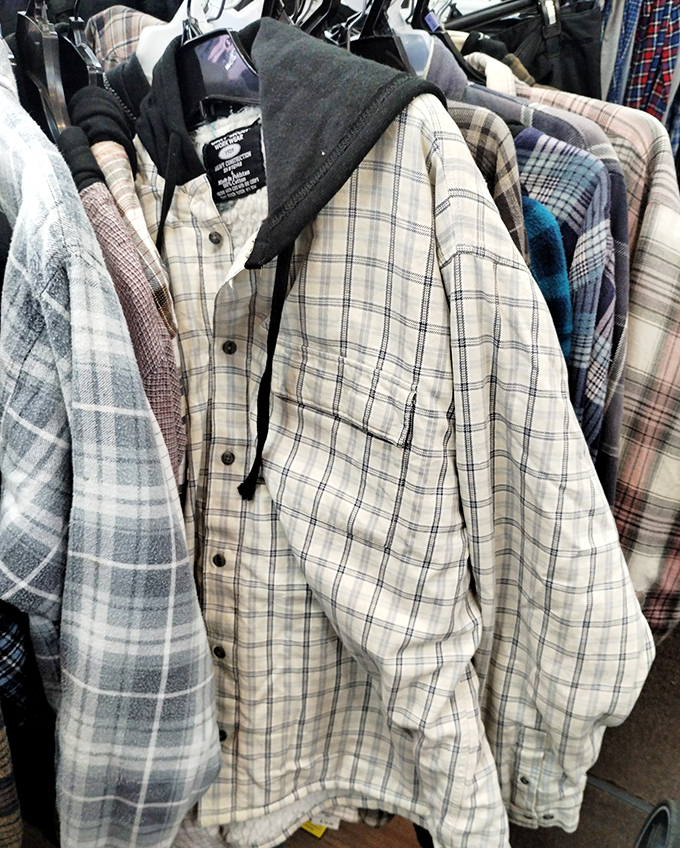 Plaid shirts hanging with the quiet dignity of lumberjacks at a formal dance. At these prices, flannel dreams become affordable reality.
