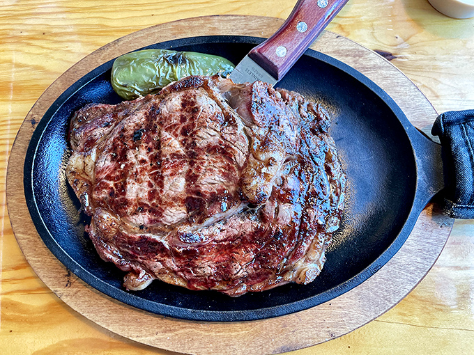 This isn't just a steak&mdash;it's a statement. The perfectly seared ribeye arrives on a sizzling platter, a carnivore's dream come true.
