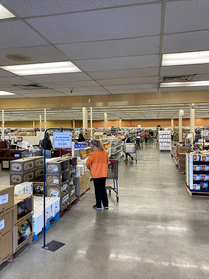 The wide, well-lit aisles invite exploration, where shoppers push carts with the focused determination of archaeologists on the verge of discovery.