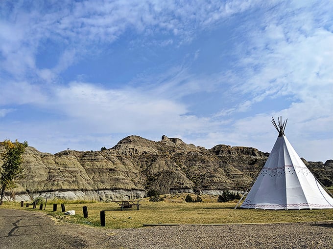 A teepee against ancient badlands—where modern camping meets landscapes that have remained unchanged for millennia.