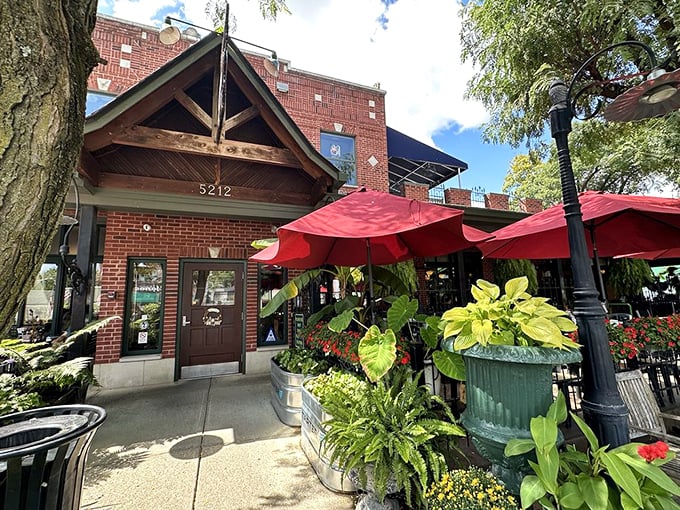 The Aristocrat's charming brick exterior and lush greenery create an inviting oasis. Those red umbrellas beckon sandwich lovers.