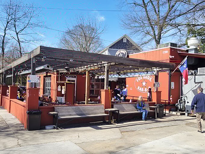 Fox Bros' rustic-red patio invites you to dine al fresco. Those yellow umbrellas are like beacons of barbecue happiness on a sunny day.