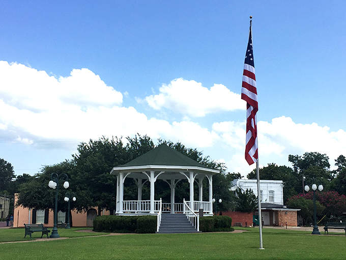 The classic American town square in Jefferson, complete with gazebo, flag, and enough history to fill a semester-long course.