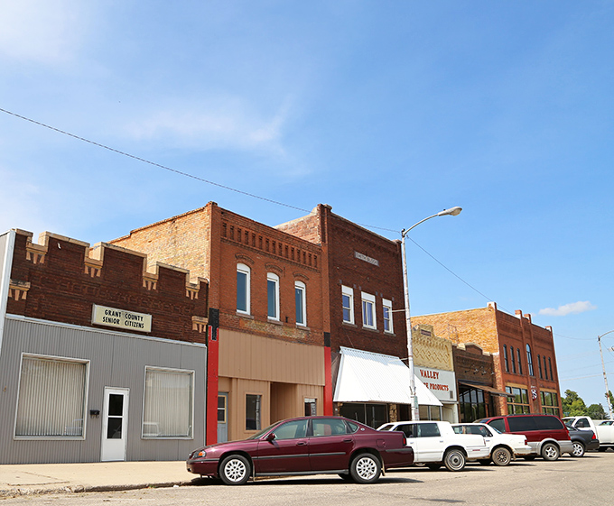 Historic brick storefronts line Milbank's main street, showcasing the beautiful pink quartzite stone that makes this town architecturally unique and charming.