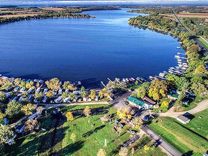 Lake Osakis sparkles like a sapphire, with docks and cabins nestled along its peaceful shoreline.