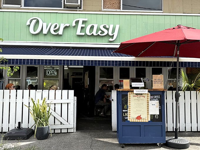 Over Easy&rsquo;s charming white picket fence and green-painted wall create the perfect breakfast picket line. The red umbrella adds a pop of morning energy.