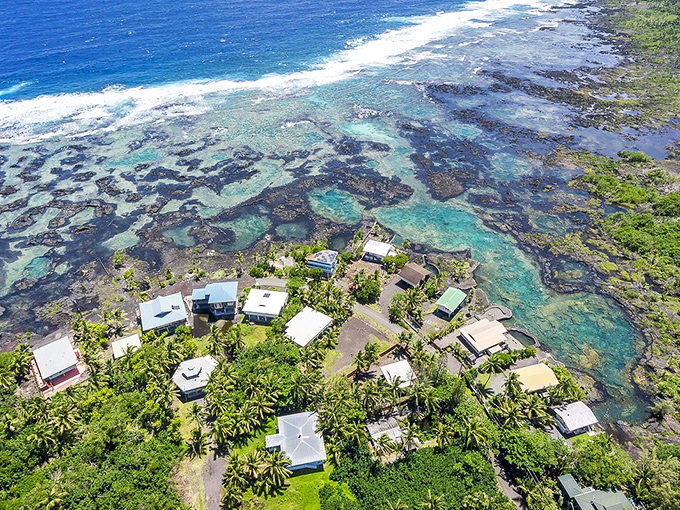 Pahoa's rolling hills stretch toward the horizon. That little cluster of homes has front-row seats to Hawaii's most spectacular show.