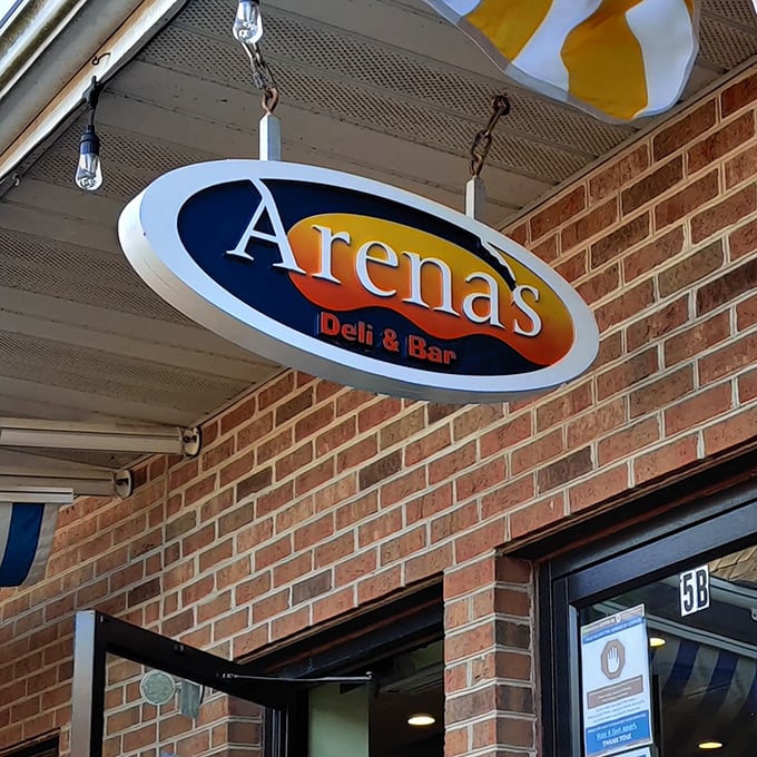 The hanging oval sign at Arena's promises deli delights inside this brick-fronted beach town favorite.