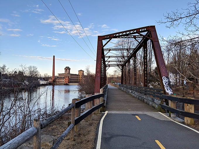 The old railroad bridge offers walkers and cyclists a perfect view of Coventry's industrial heritage along the peaceful waterway.