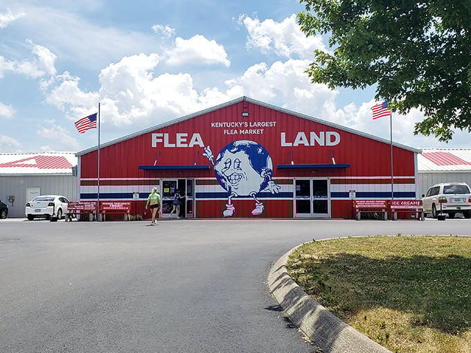 The iconic red barn of Flea Land, Kentucky's largest flea market, welcomes treasure hunters under blue summer skies.