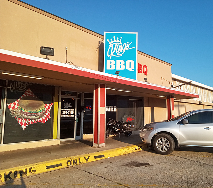 The bright turquoise "Kings BBQ" sign pops against the beige building. That crown logo isn't just for show&mdash;this place rules the smoke.