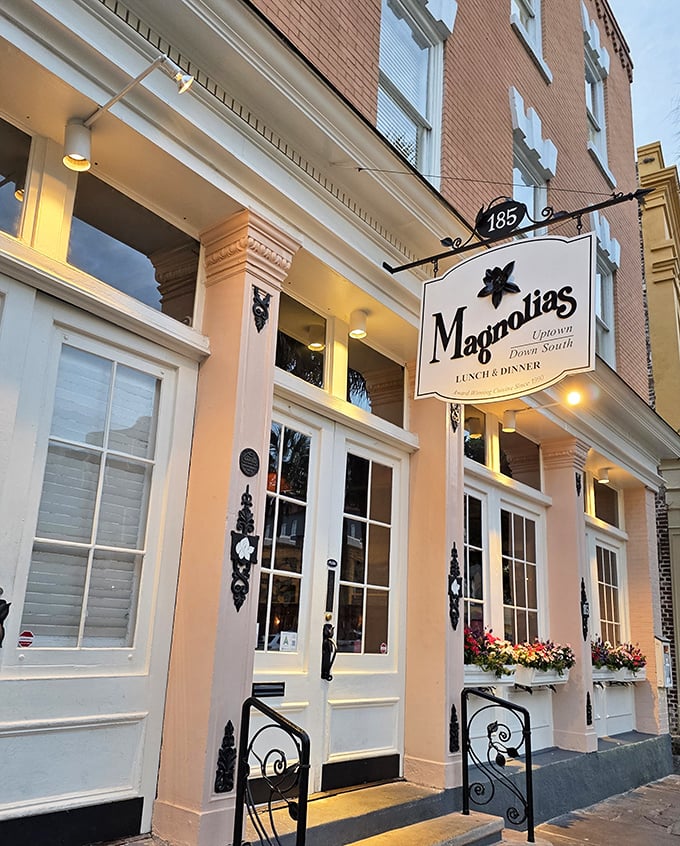 The soft glow of the light bathes Magnolias' sophisticated fa&ccedil;ade, setting the stage for a memorable dining experience in historic Charleston.