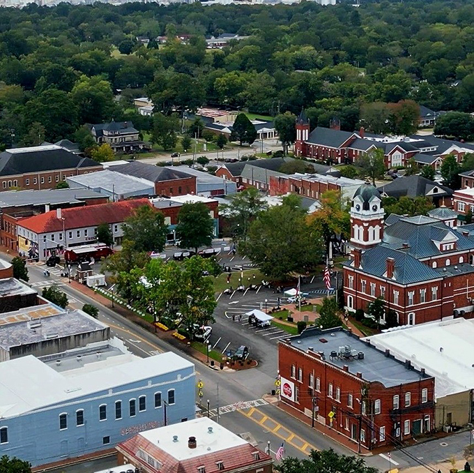Historic Sandersville from above, where brick buildings and tree-lined streets create a peaceful small-town panorama.