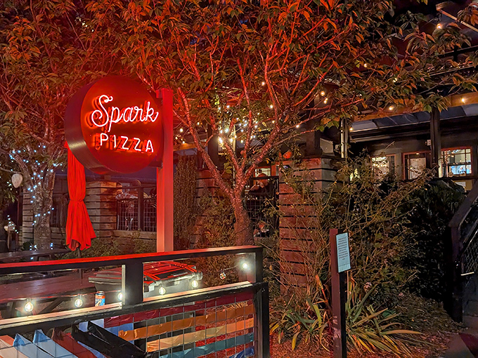 That glowing red neon sign isn't just advertising&mdash;it's a lighthouse guiding hungry souls to wood-fired pizza salvation.