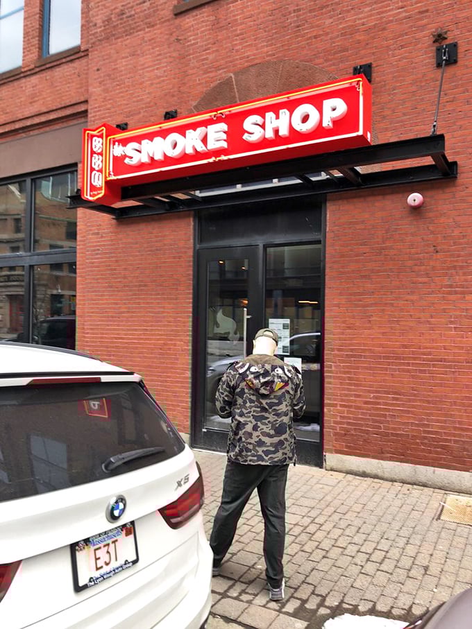 The Smoke Shop's bold red sign beckons BBQ lovers to its brick-walled Seaport location in Boston.