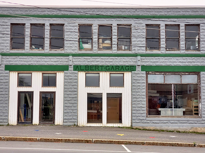 Albert Garage stands as a testament to mid-century automotive architecture. That classic green trim against the stone facade is pure Americana.