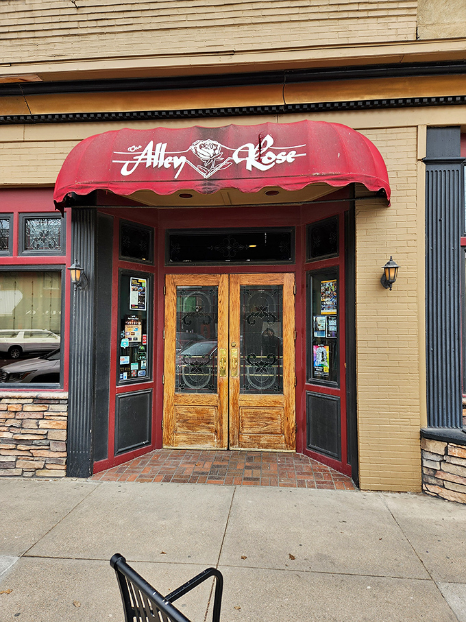 Alley Rose's inviting entrance promises culinary delights behind those wooden doors. The red awning practically whispers, "Come in, you're going to love this."