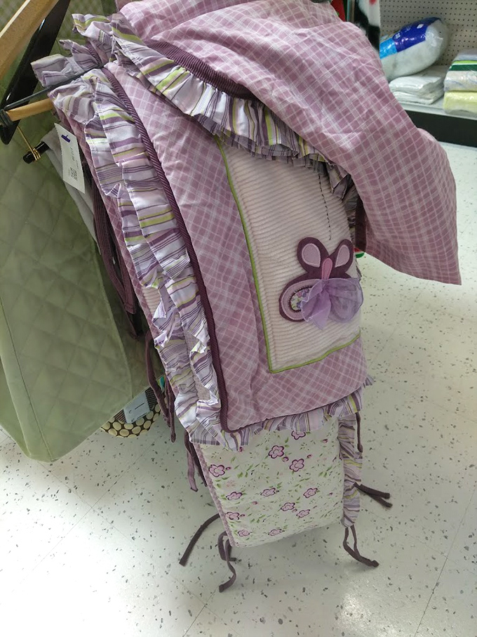 Nursery items cycle through Goodwill faster than babies outgrow them. This purple bedding set awaits its next tiny occupant.