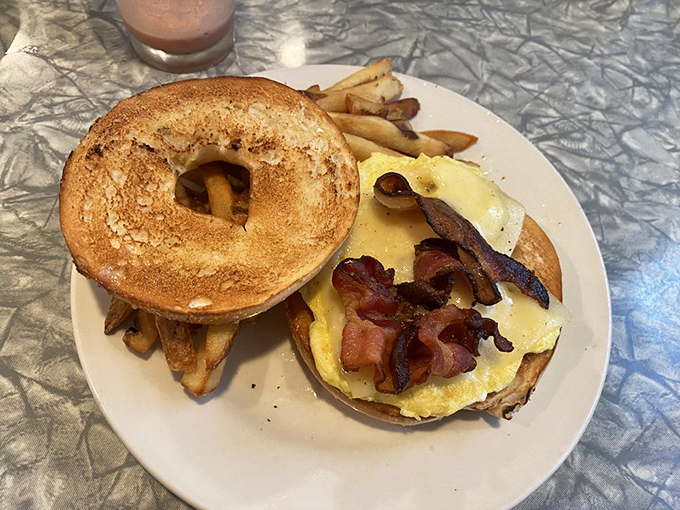 The breakfast sandwich that launched a thousand satisfied sighs. That toasted bagel cradles eggs and bacon like they're precious cargo&mdash;because they are.