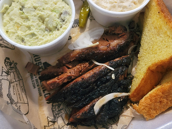 Brisket slices with a bark so perfect it should be hanging in a barbecue museum, alongside a slice of white bread that knows its supporting role.