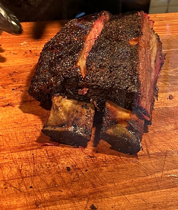 Beef ribs so magnificent they'd make Fred Flintstone weep with joy. That smoke ring isn't just pink&mdash;it's practically blushing from all the attention.
