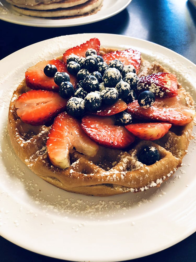 A Belgian waffle that's dressed for success with fresh berries and a light snowfall of powdered sugar. Breakfast or dessert? The line deliciously blurs.