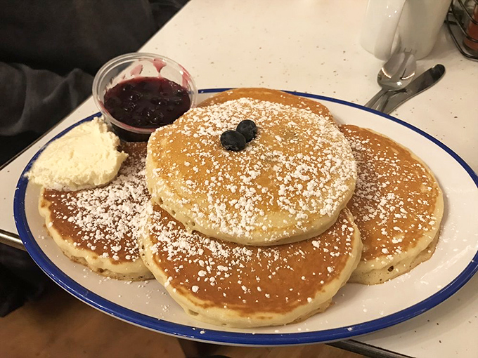 Powdered sugar snowfall on blueberry-studded pancakes with compote on standby. Breakfast doesn't get more photogenic&mdash;or delicious&mdash;than this.
