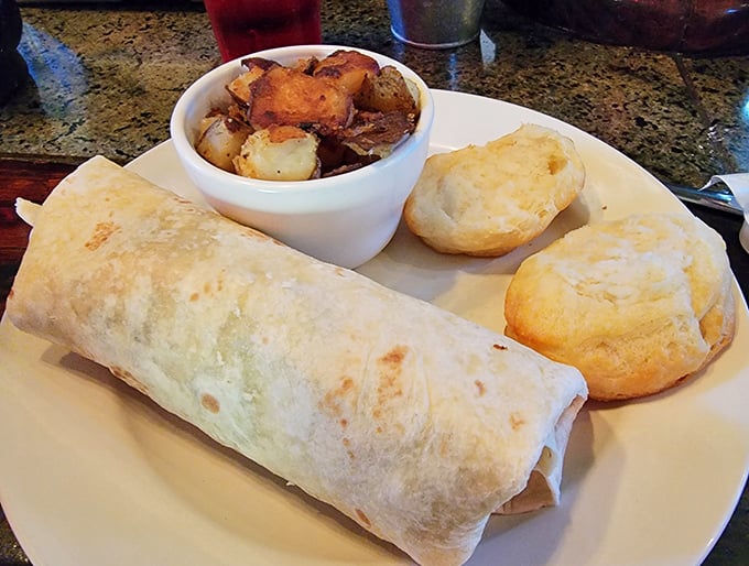 The breakfast burrito comes with home fries and biscuits because one carb is never enough here.