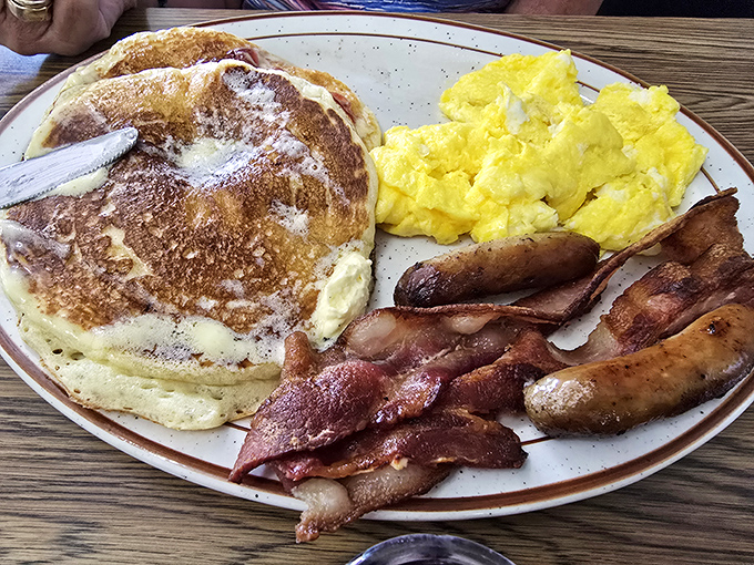 The breakfast trinity: golden pancakes, perfectly scrambled eggs, and bacon cooked just right&mdash;simple pleasures that never go out of style.