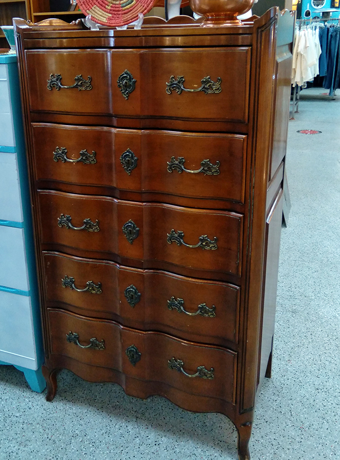 Not just a dresser—a time machine with drawers. This French Provincial beauty has probably seen more outfit changes than a Broadway production.