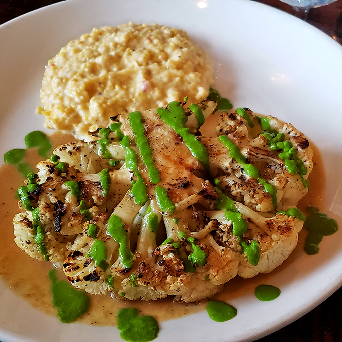 The cauliflower "steak" proves vegetables can be show-stoppers too, with a vibrant green sauce that makes you momentarily forget about beef entirely.
