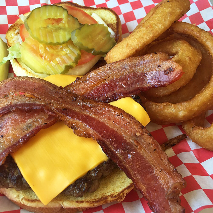 This isn't just a bacon cheeseburger; it's edible architecture with layers of melty cheese, crispy bacon, and a hand-formed patty on a perfectly toasted bun.