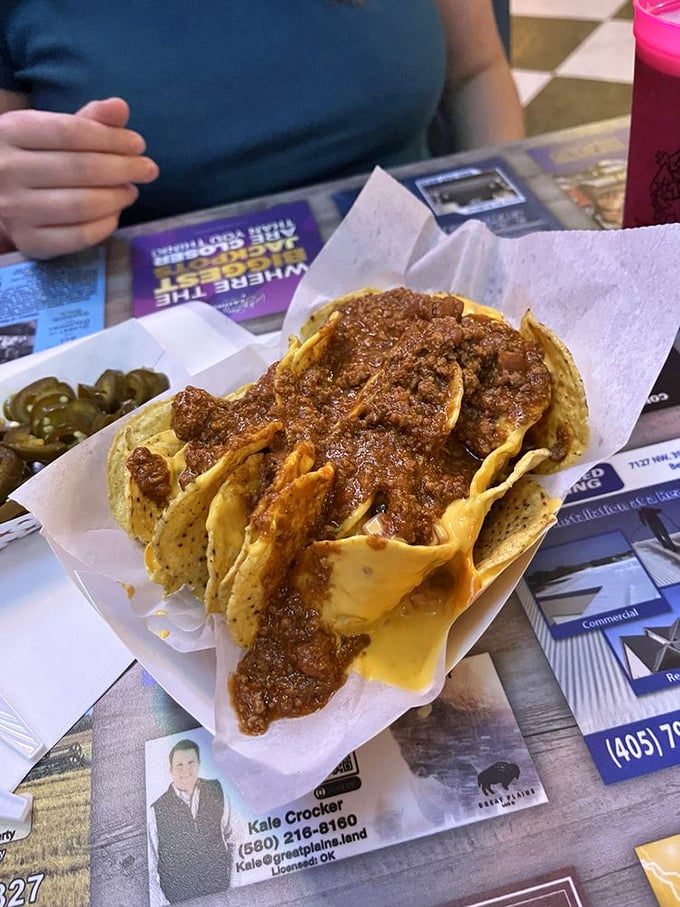 Jalape&ntilde;os standing guard over a mountain of chili and cheese. This isn't just nachos&mdash;it's an edible monument to comfort food.