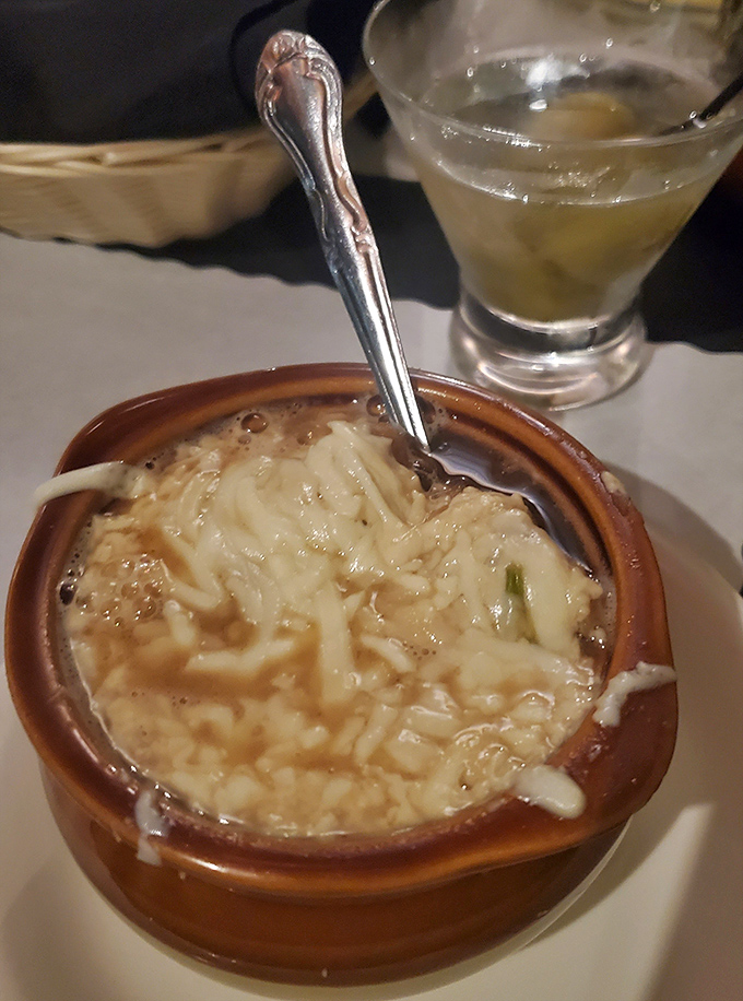 This isn't just French onion soup; it's a cheese-crowned masterpiece where gooey, stretchy goodness meets savory broth in perfect harmony.