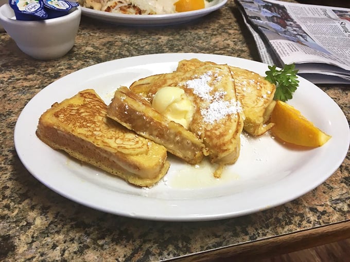 French toast that's had a proper education &ndash; thick-cut, golden-brown, and dusted with powdered sugar. Breakfast nobility at its finest.