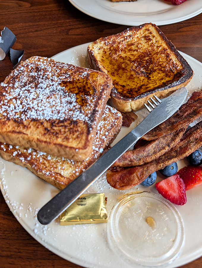 French toast dusted with powdered sugar and surrounded by fresh berries – breakfast that's worth purring about.