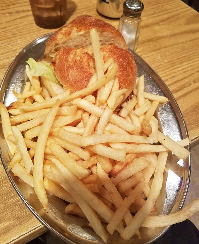 French fries so perfectly golden they deserve their own Instagram account, paired with a sandwich that puts desk lunches everywhere to shame.