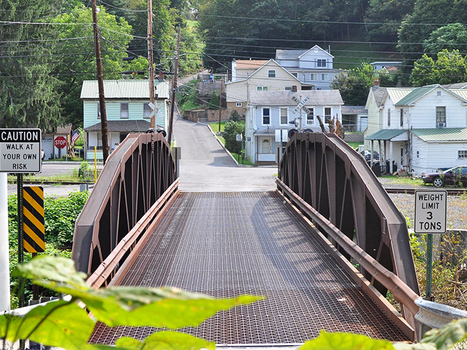 "Walk at your own risk" reads the sign, but this charming iron bridge has been connecting Westernport neighborhoods far longer than most modern relationships last.