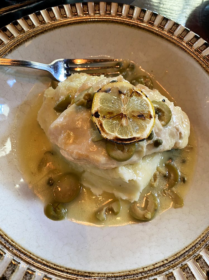 Lemon chicken perched atop mashed potatoes with capers playing hide-and-seek in a buttery sauce that demands to be sopped up with bread.